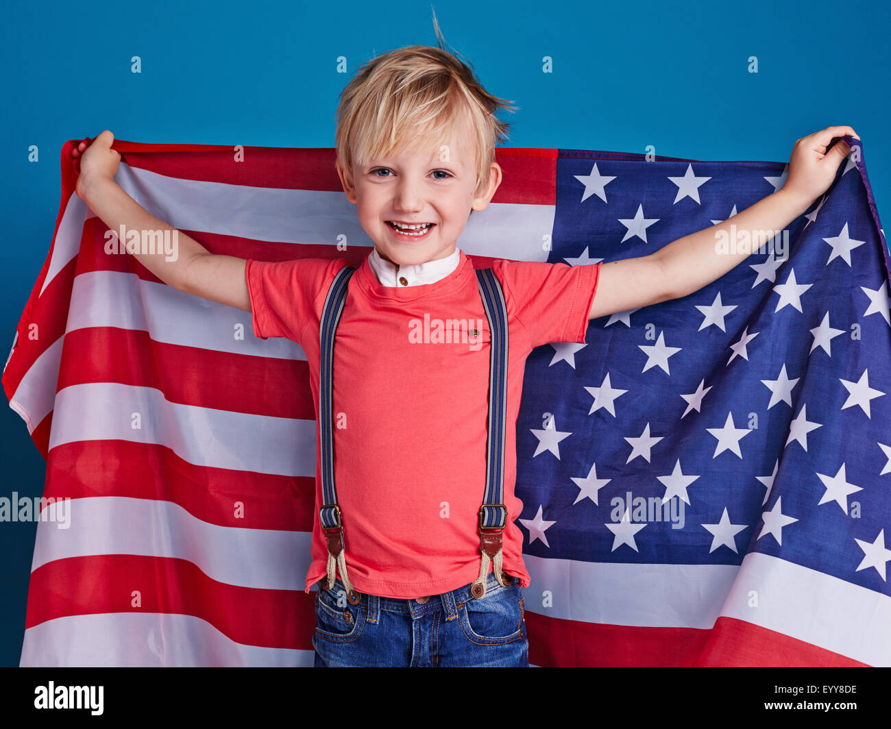 Happy kid with American flag looking at camera Stock Photo - Alamy