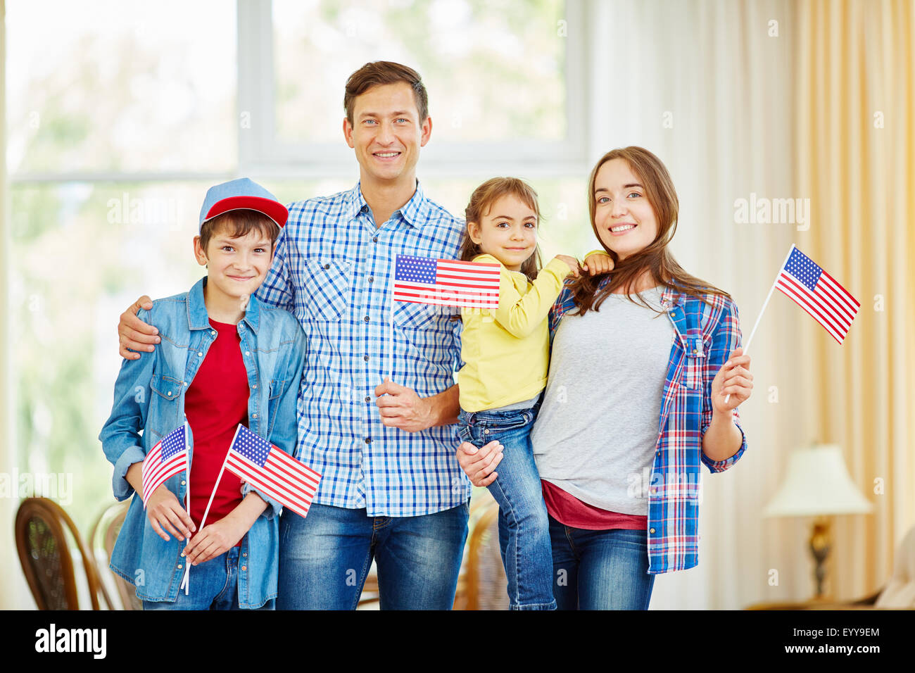 Modern American family looking at camera with smiles Stock Photo - Alamy