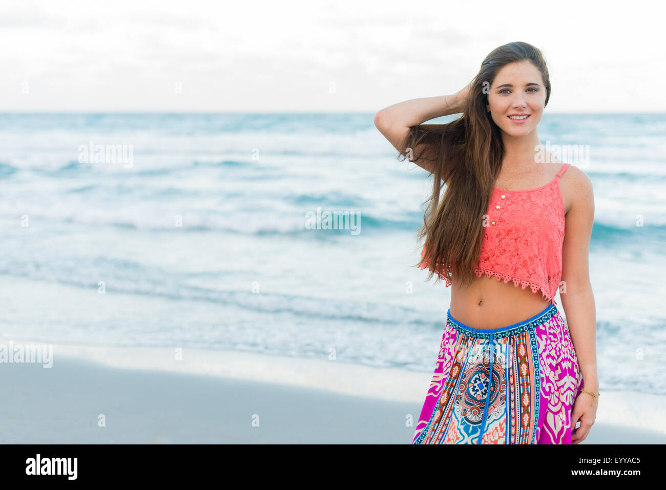 Hispanic woman standing on beach Stock Photo - Alamy