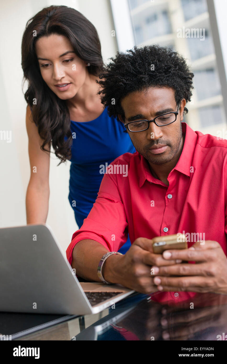 Hispanic business people working at office desk Stock Photo - Alamy