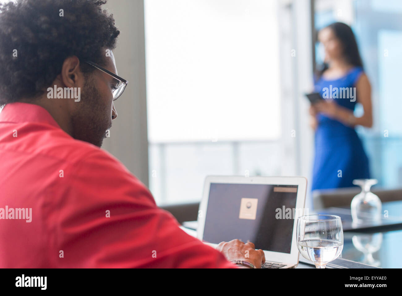 Hispanic businessman using laptop at conference table Stock Photo - Alamy