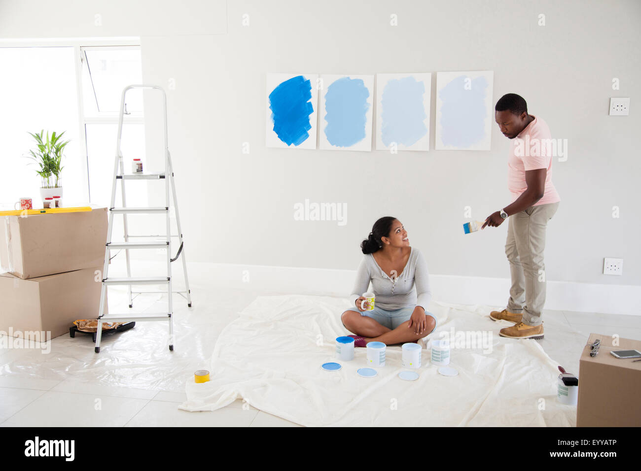 Couple examining paint samples in new home Stock Photo - Alamy