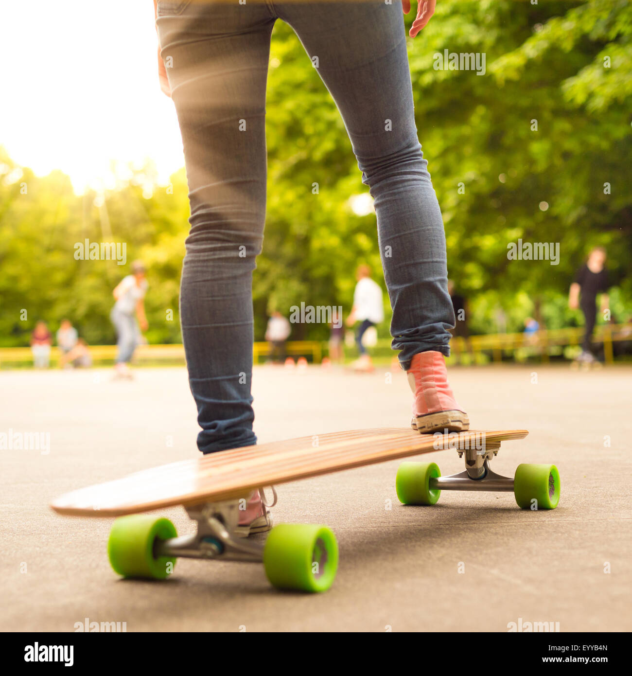 Girl practicing urban long board riding Stock Photo - Alamy