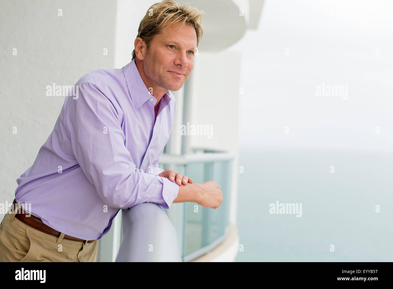 Man leaning on balcony hi-res stock photography and images - Alamy