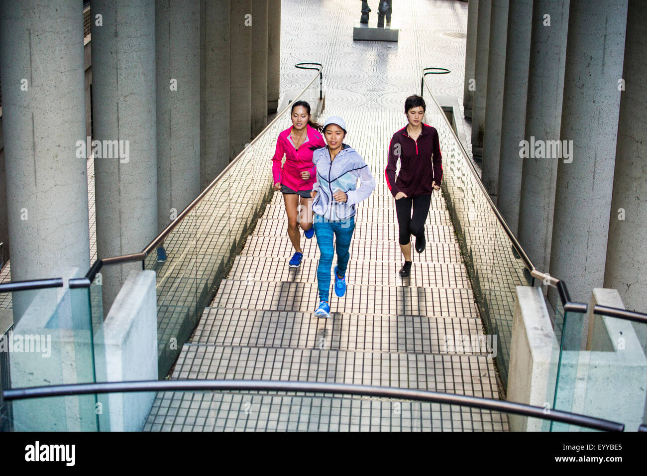 High angle view of women running on staircase Stock Photo - Alamy