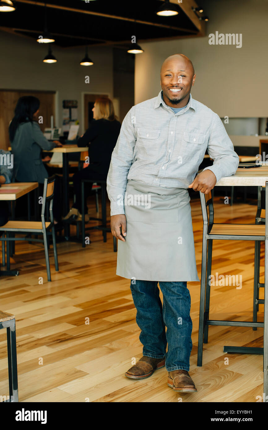 Black waiter smiling in in cafe Stock Photo - Alamy