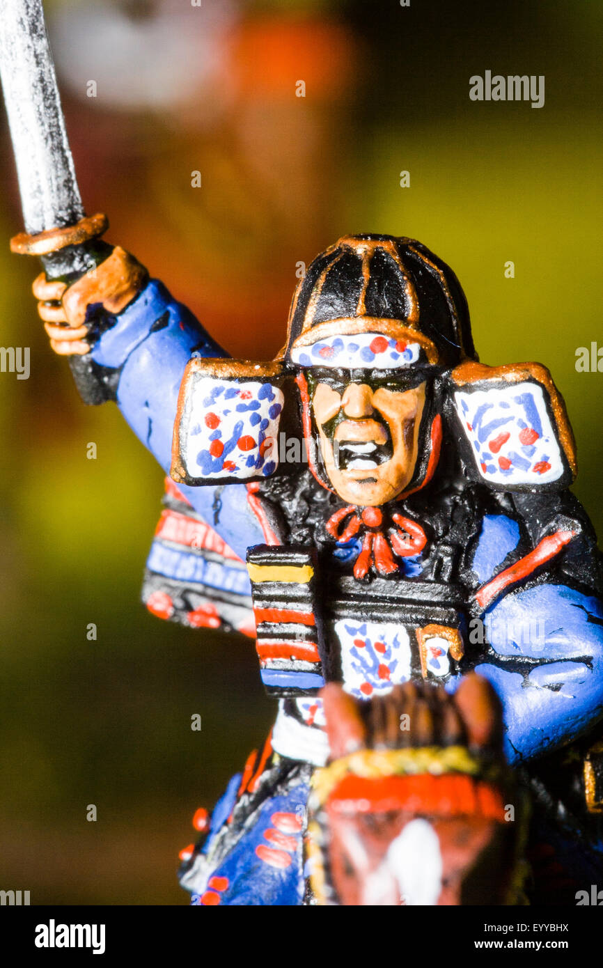 Close-up of metal painted scale model figures. Mounted Japanese samurai ...