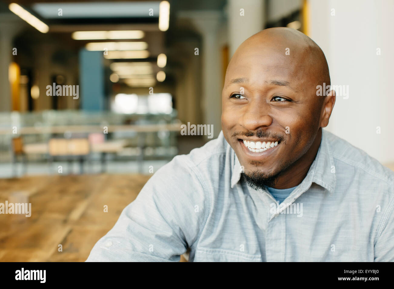 Black man smiling in cafe Stock Photo - Alamy