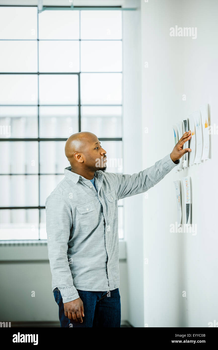 Mid adult man standing front black wall hi-res stock photography and ...