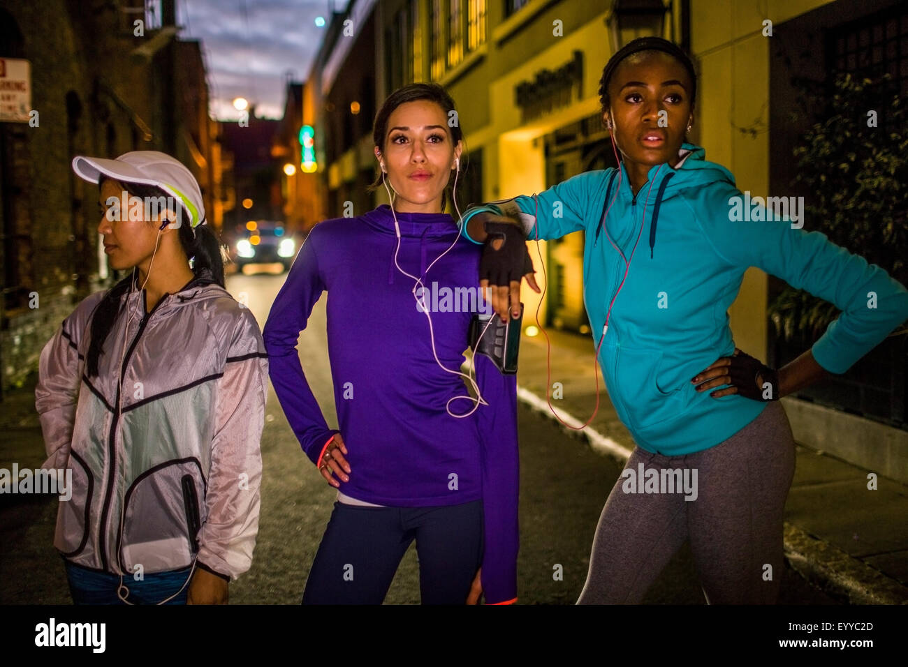 Runners standing on city street at night Stock Photo - Alamy
