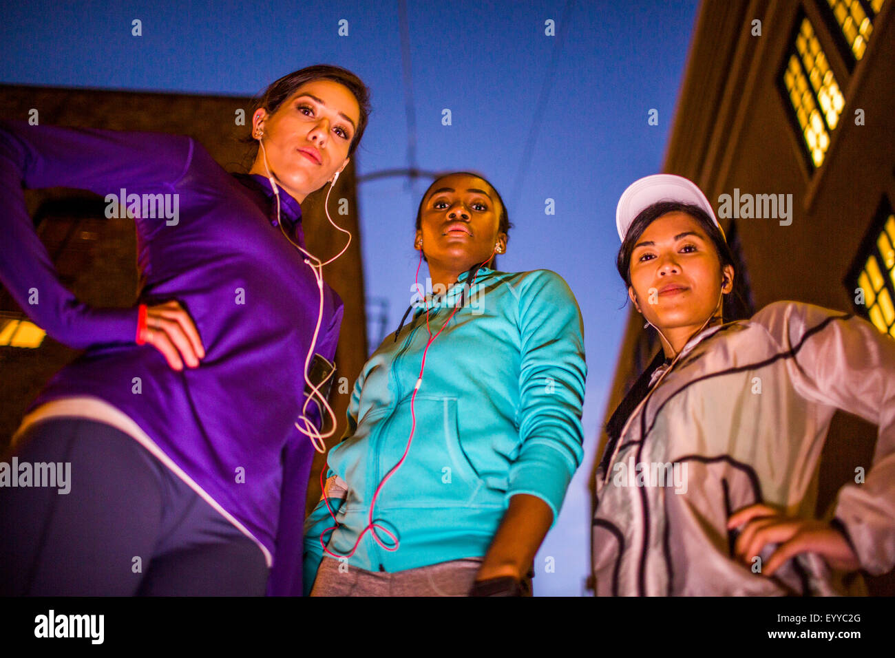 Low angle view of runners standing together at night Stock Photo - Alamy