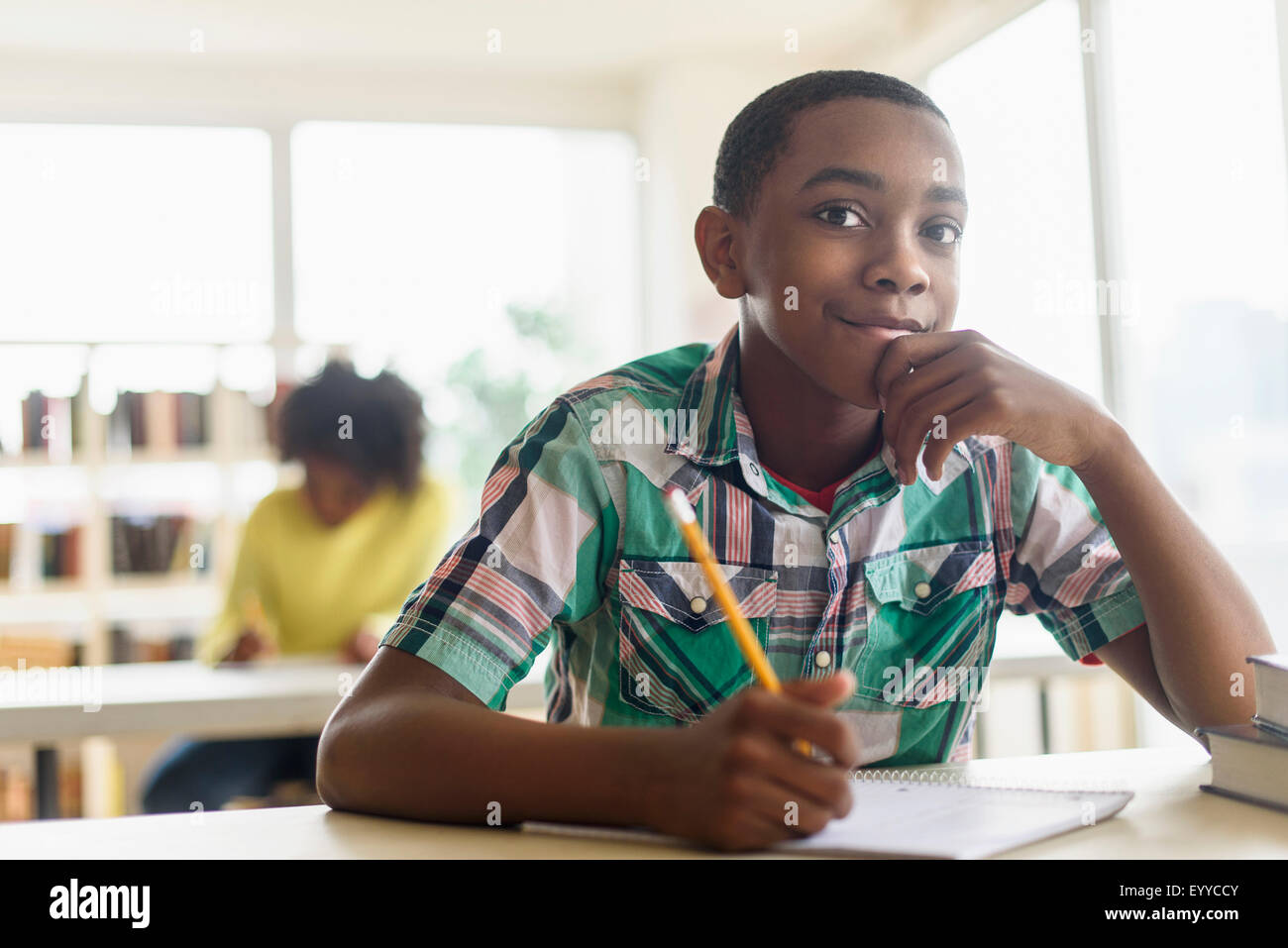 Black student thinking in classroom Stock Photo - Alamy
