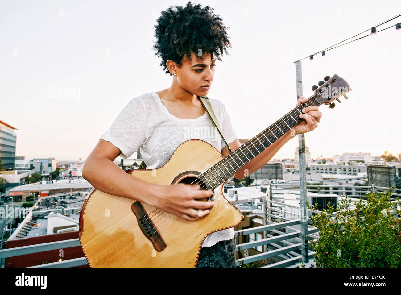 Woman playing guitar hi-res stock photography and images - Alamy