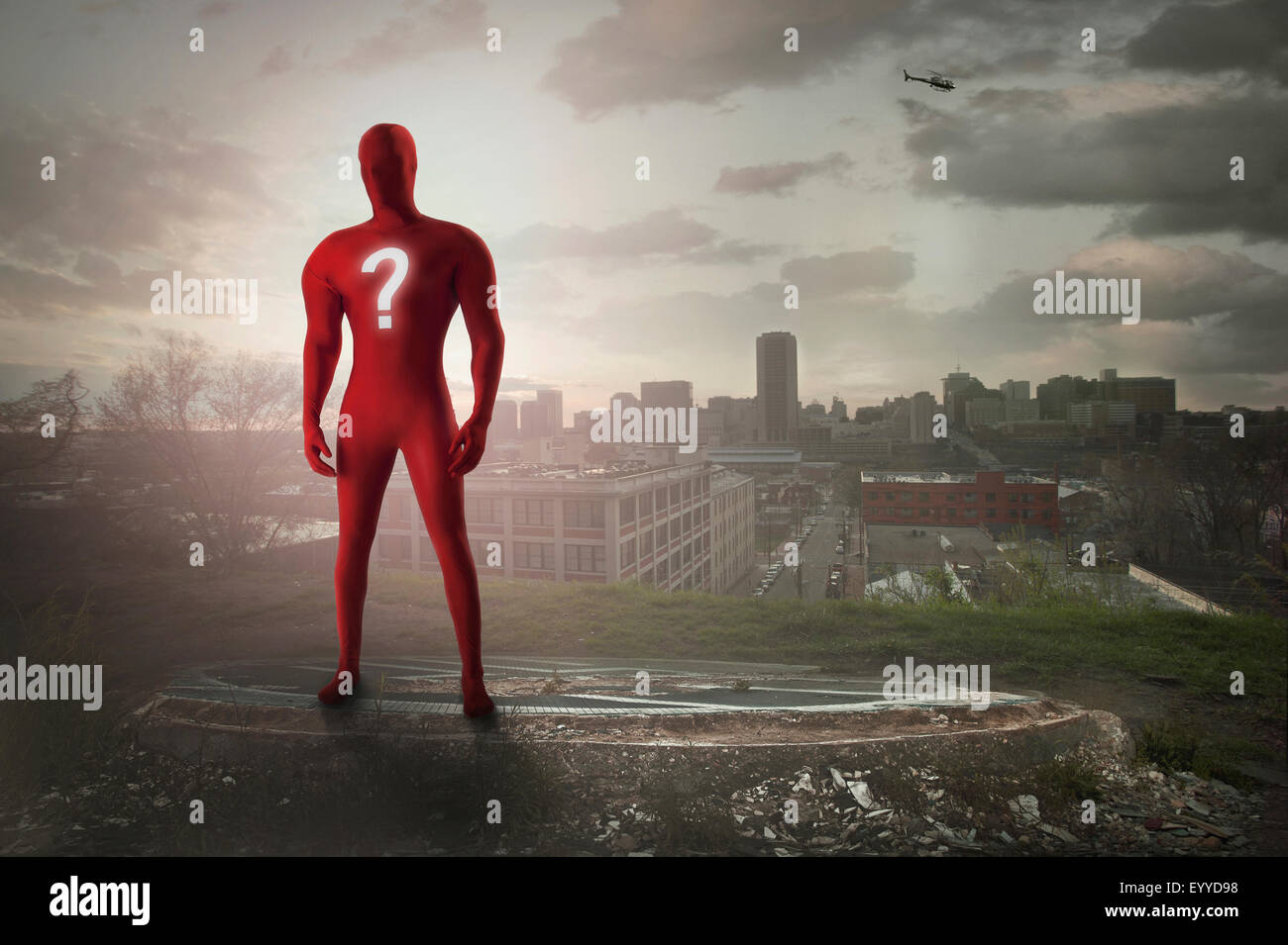 Superhero with question mark costume overlooking cityscape Stock Photo ...
