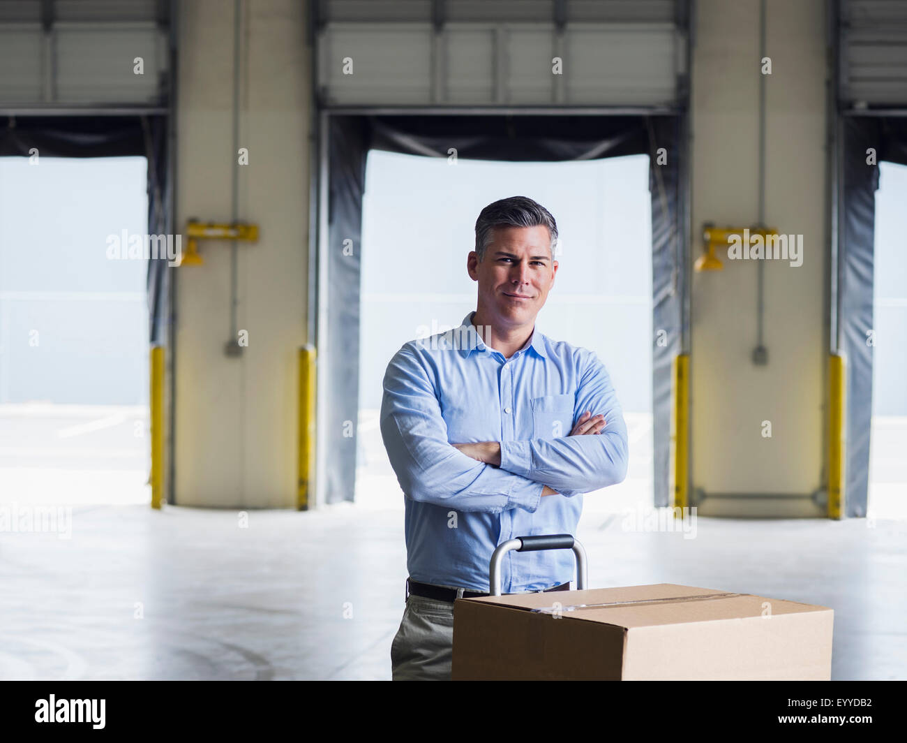 Caucasian businessman standing in warehouse Stock Photo - Alamy
