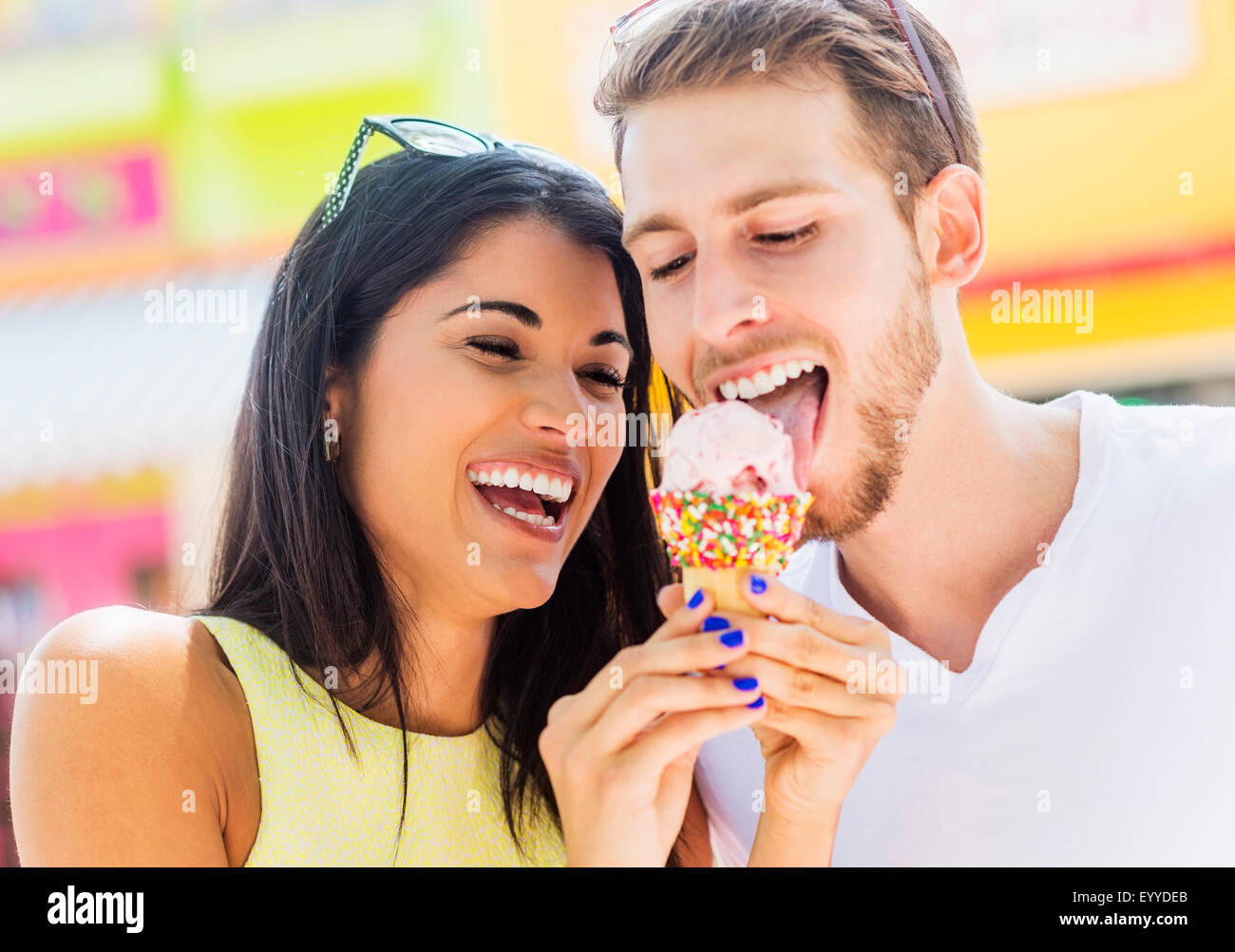 Hispanic couple sharing ice cream cone outdoors Stock Photo - Alamy