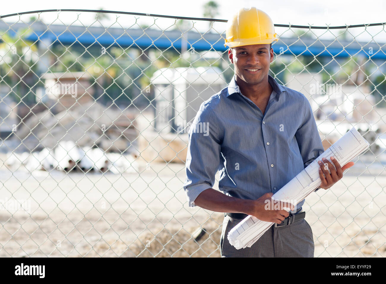 Construction worker holding hard hat hi-res stock photography and ...
