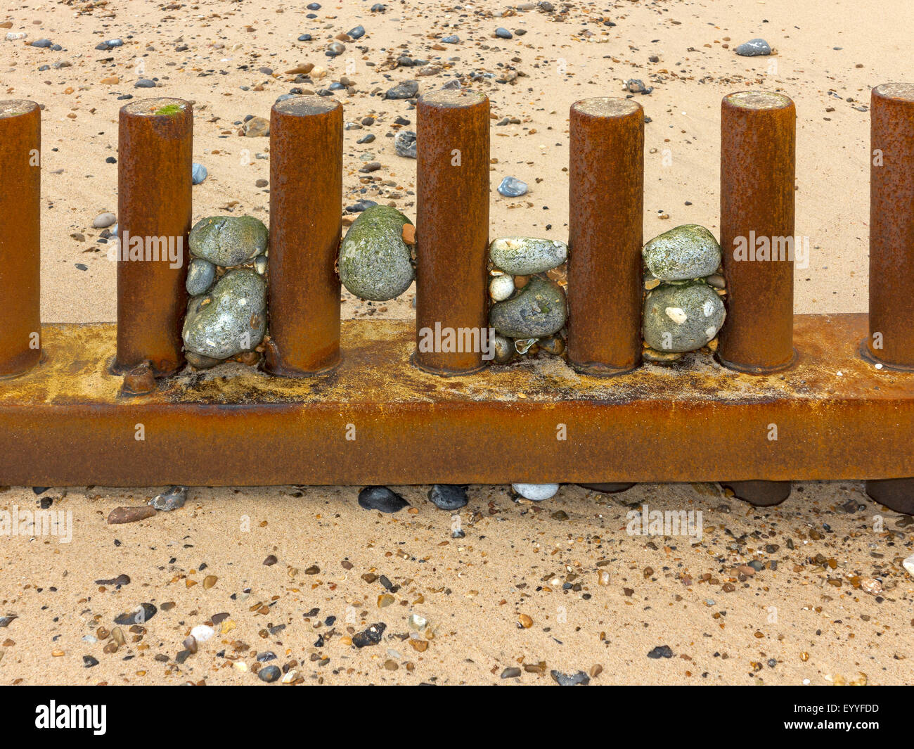 Metal groynes with trapped pebbles on a Norfolk beach Stock Photo - Alamy