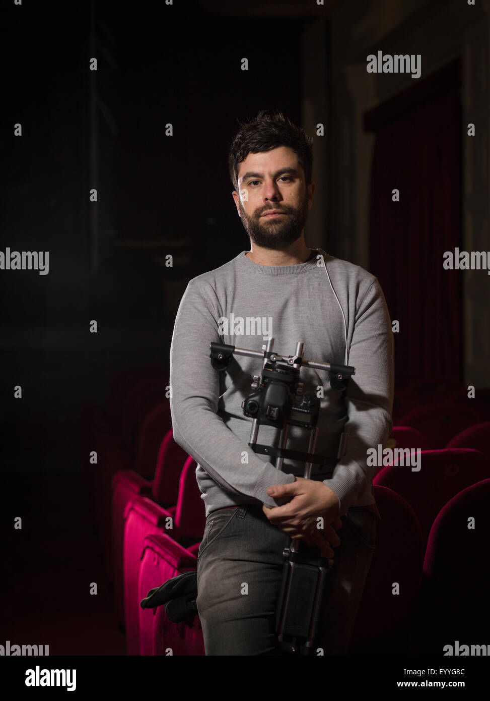 Caucasian man holding projector in movie theater Stock Photo - Alamy