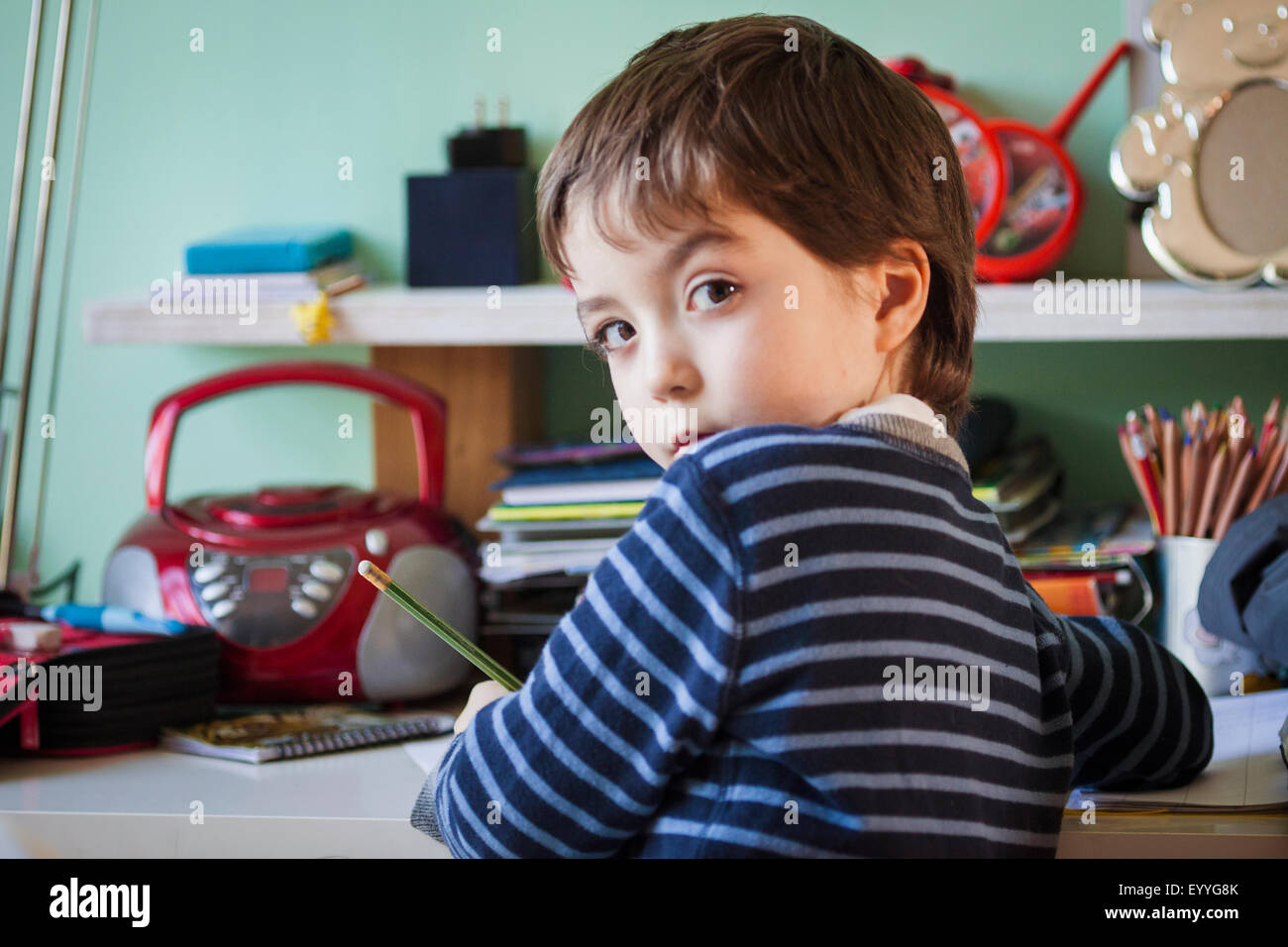 Caucasian boy giving doing homework at desk Stock Photo - Alamy
