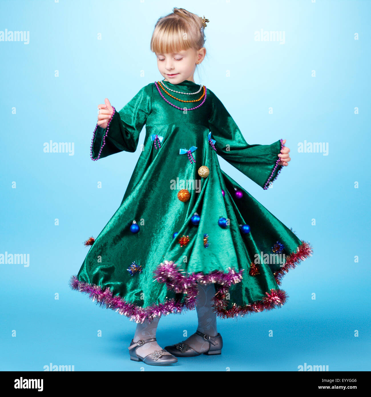 little girl with christmas tree dress Stock Photo - Alamy