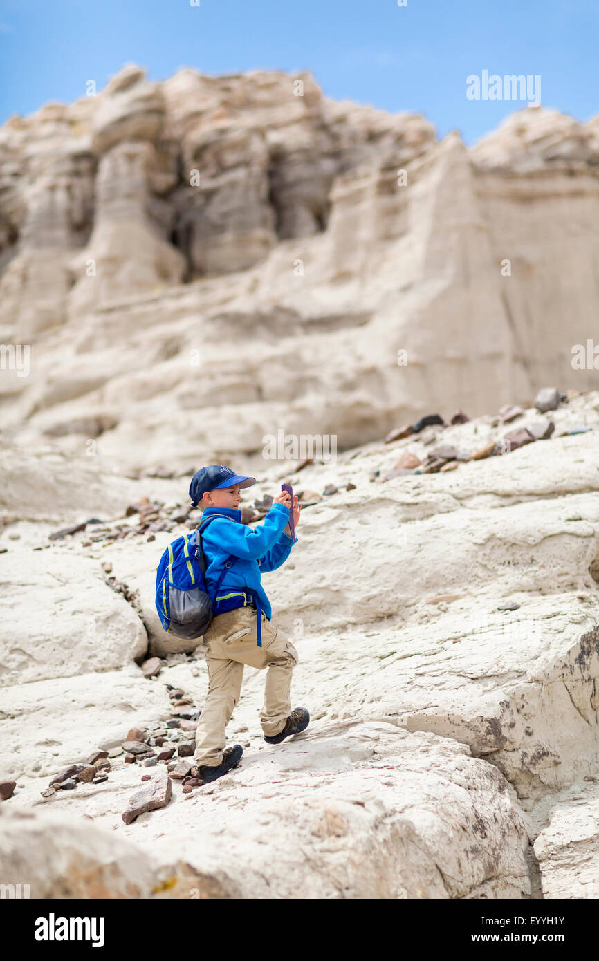 Boy photographing desert rock formations Stock Photo - Alamy