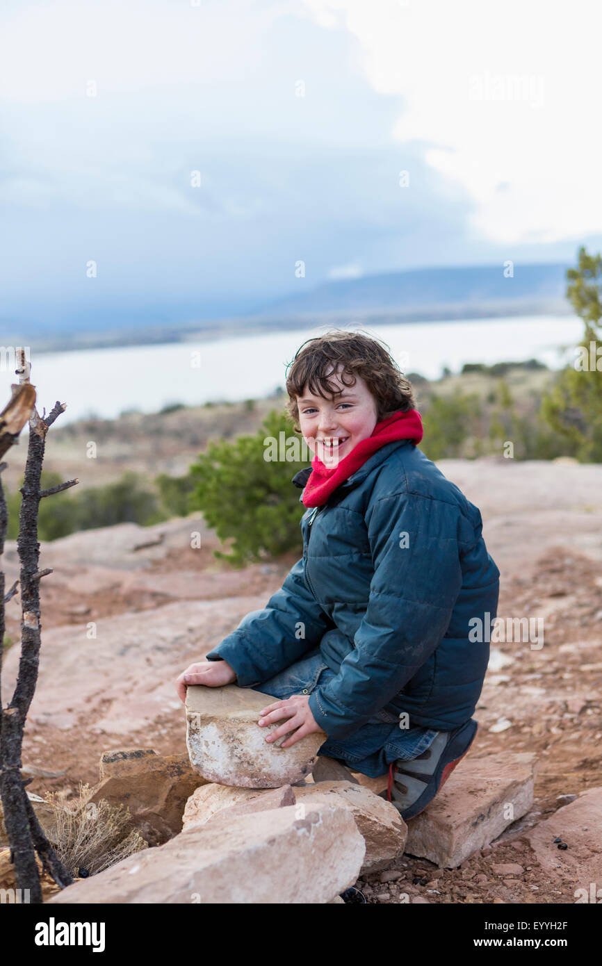 Boy examining rocks on dirt path Stock Photo - Alamy