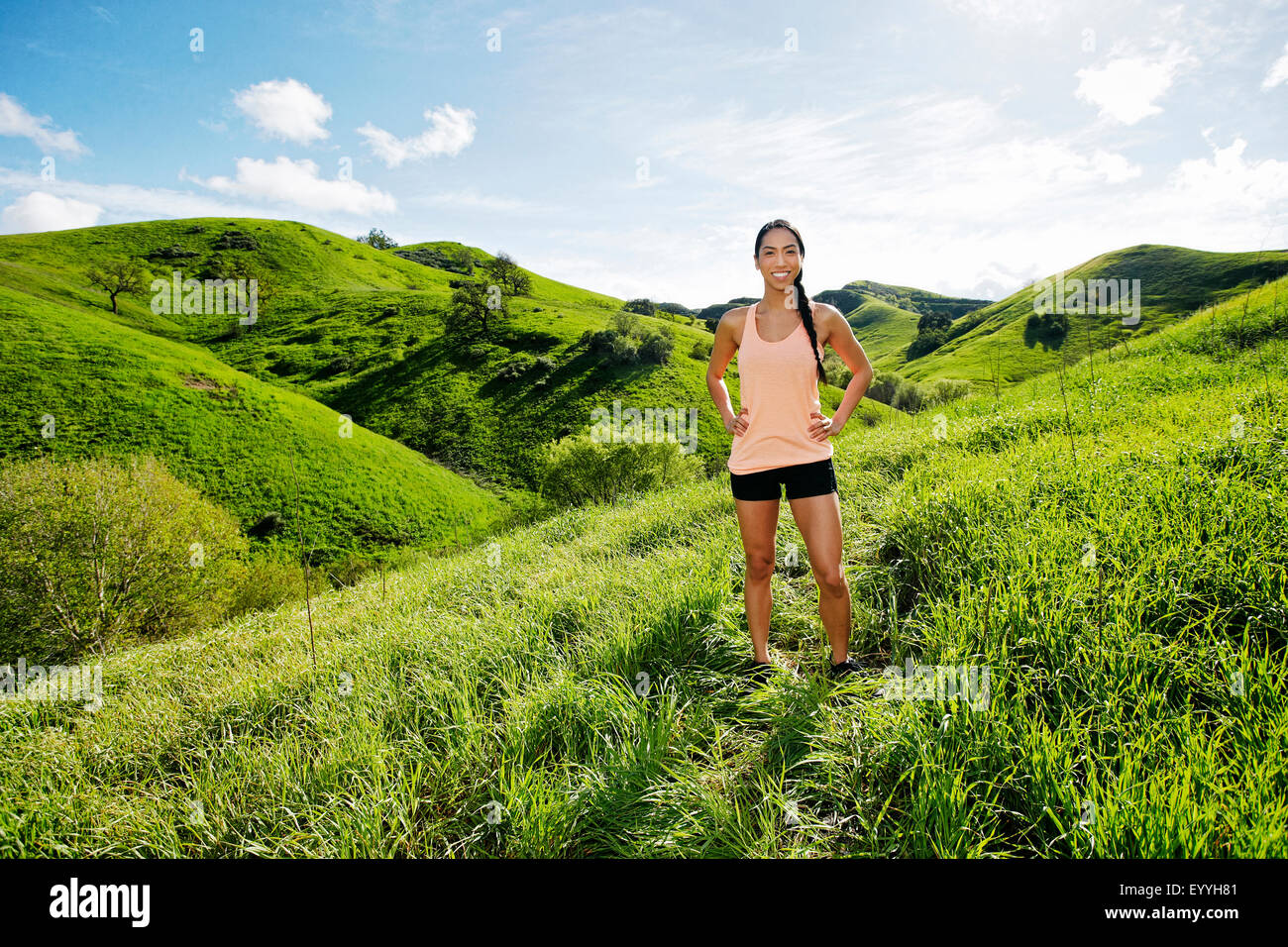 Mixed race athlete standing on rural hillside Stock Photo - Alamy