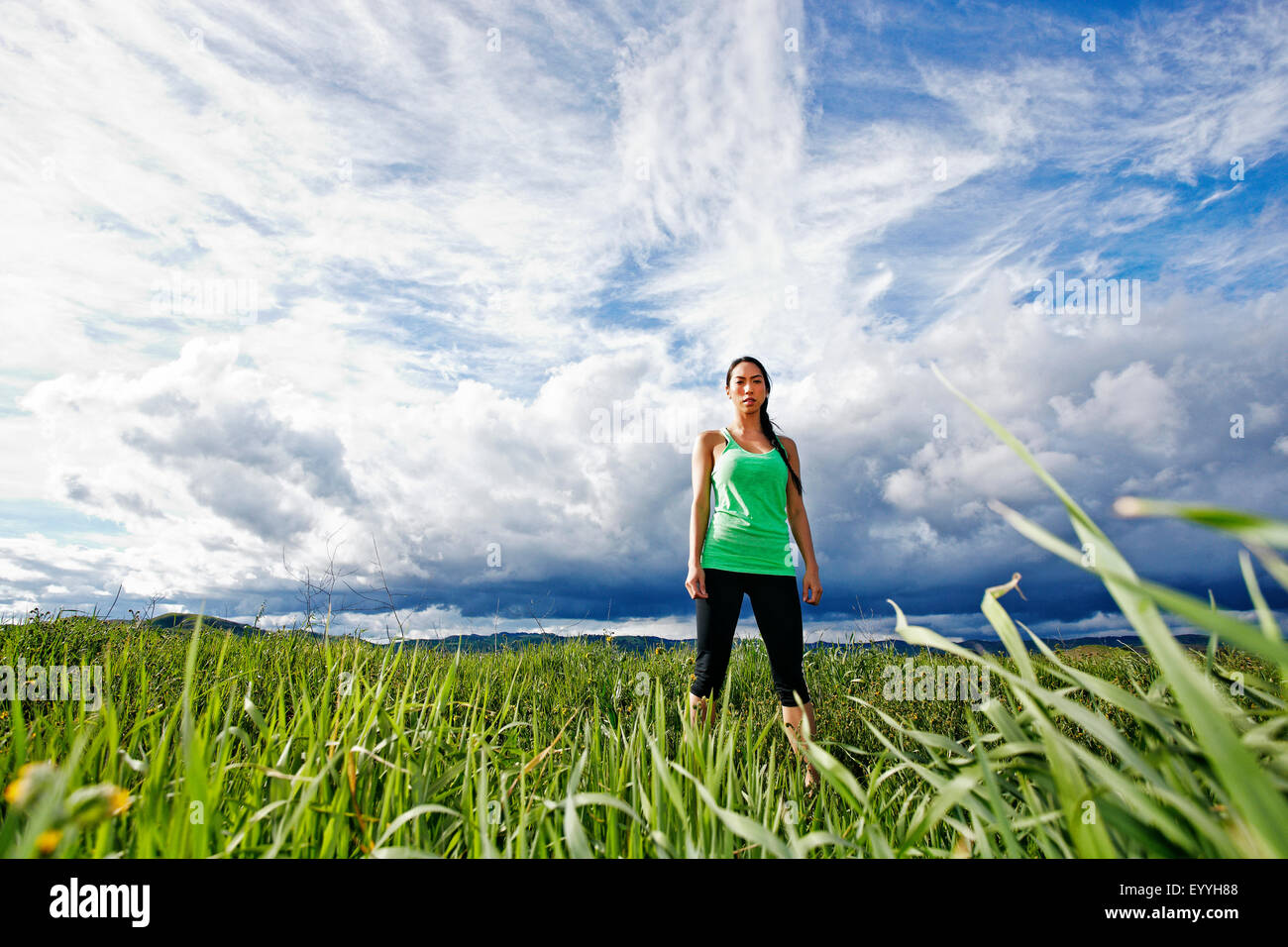 Mixed race athlete standing in rural field Stock Photo - Alamy