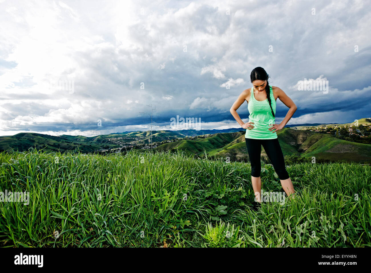 Mixed race athlete standing on rural hilltop Stock Photo - Alamy