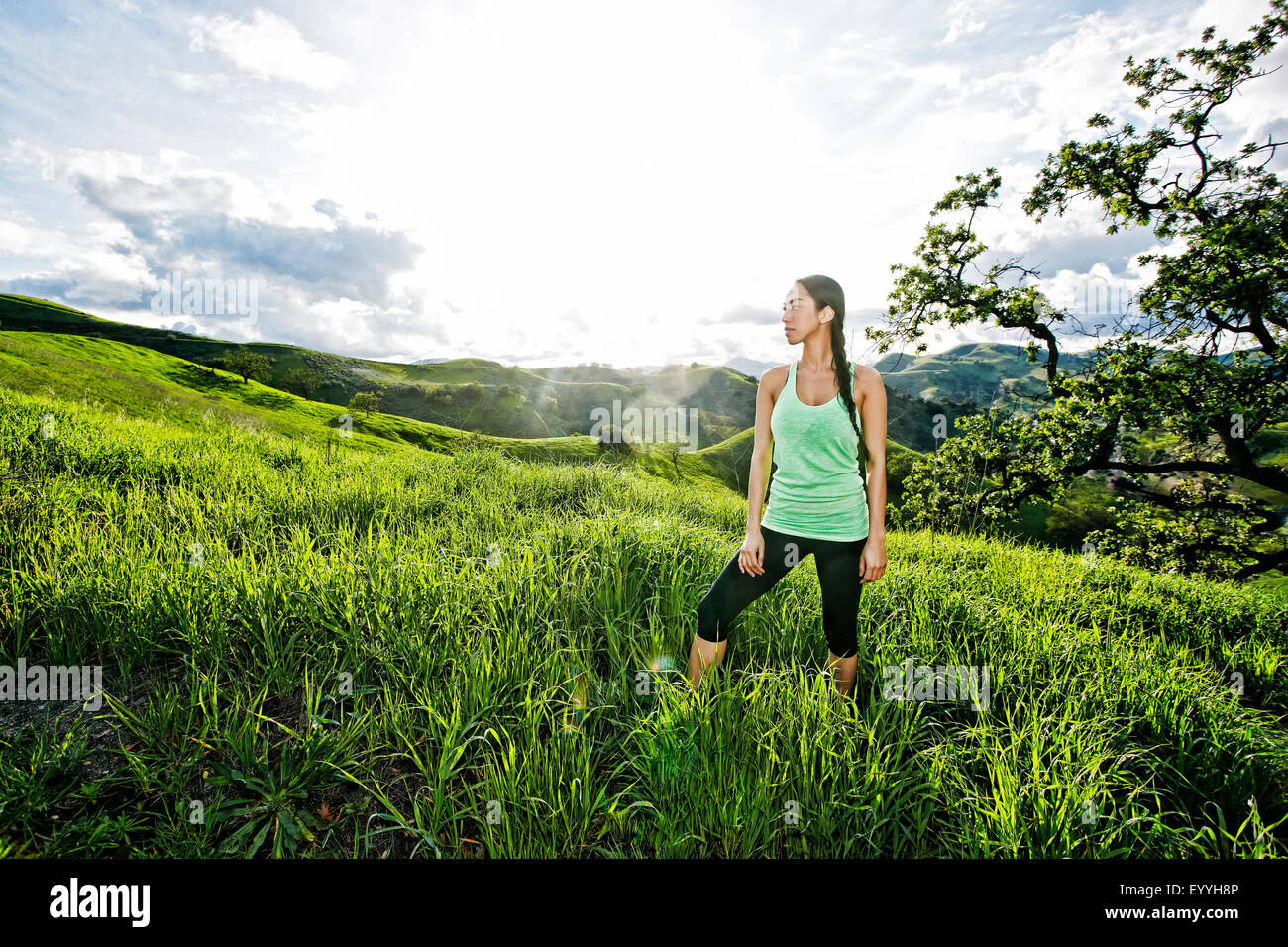 Mixed race athlete standing on rural hillside Stock Photo - Alamy