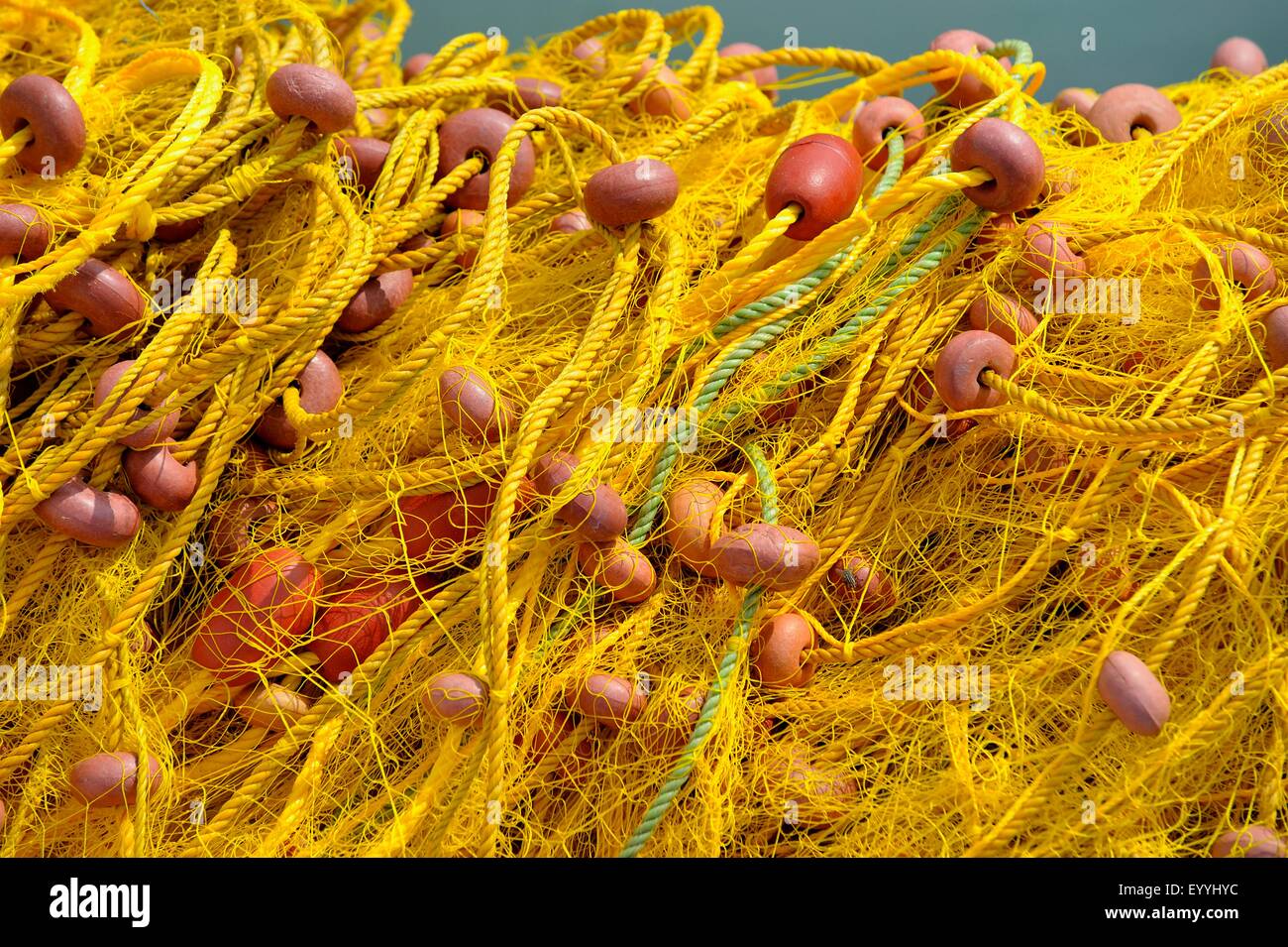 Yellow fishing nets piled up in a Greek Harbour Stock Photo - Alamy