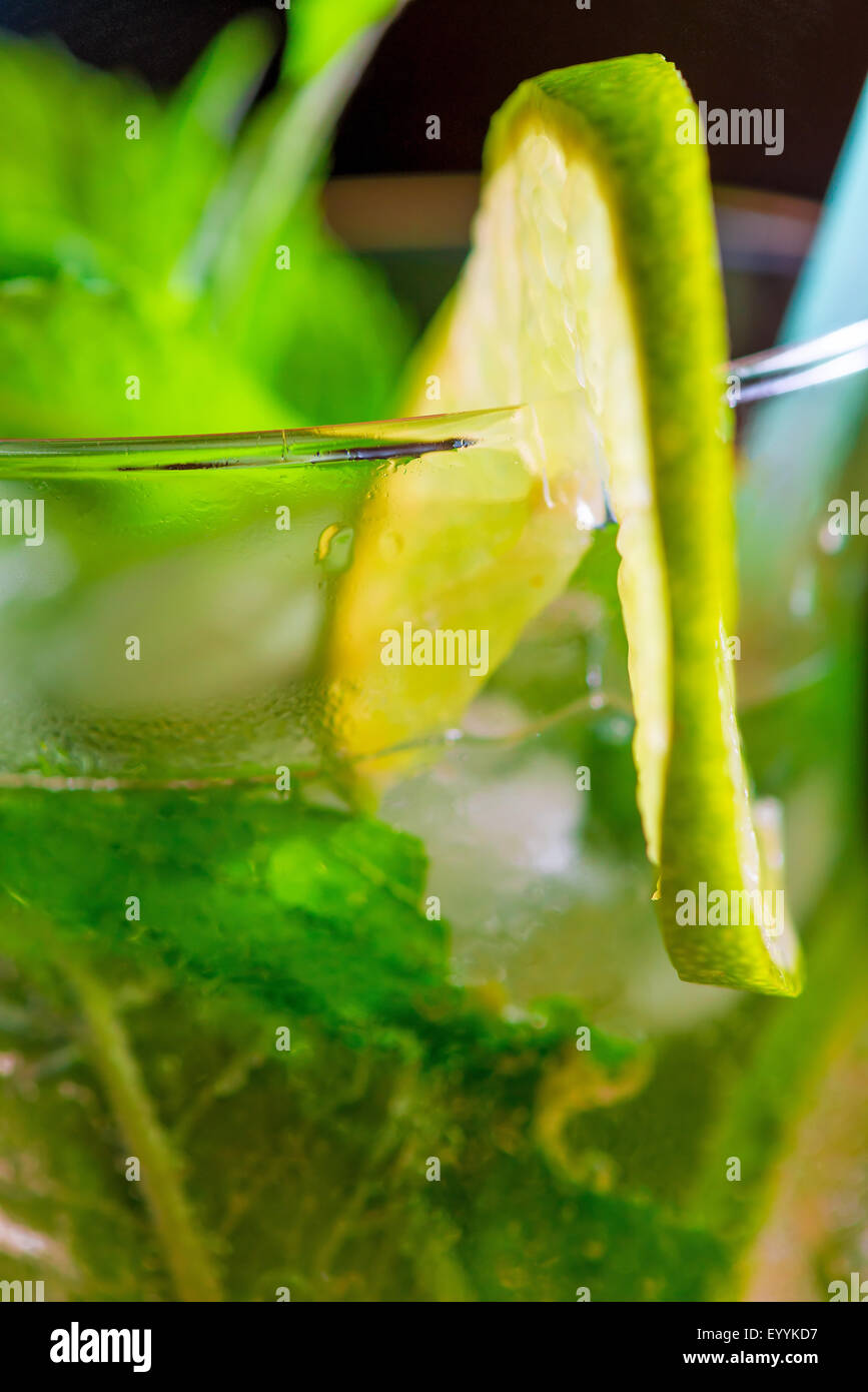 lemon lime slice on the glass with a cocktail macro Stock Photo - Alamy