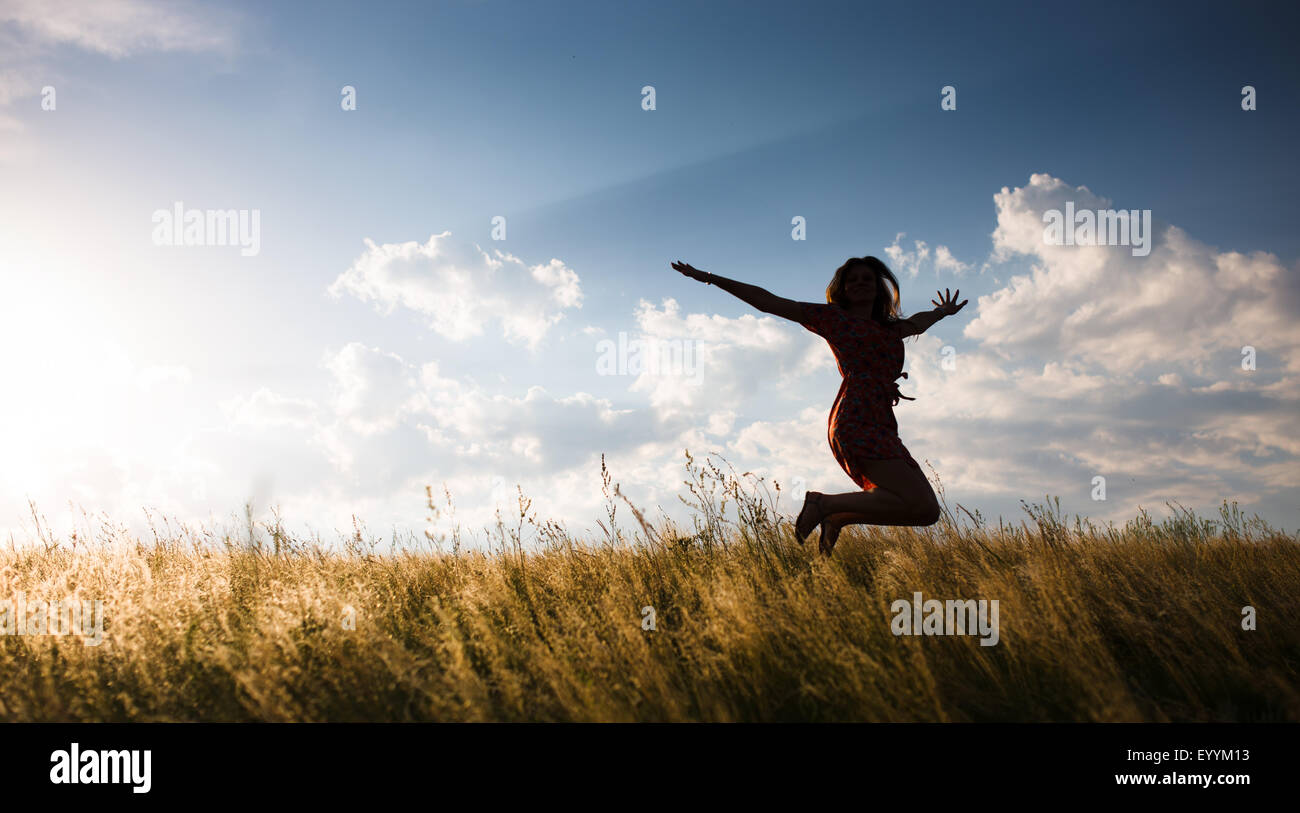 Jumping woman at sunset hi-res stock photography and images - Alamy