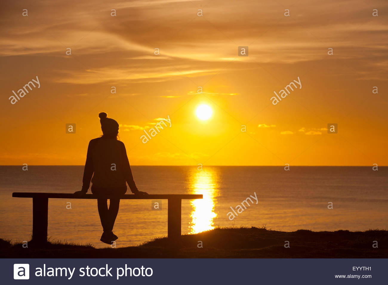 Woman Sitting Alone On Sunset Stock Photos & Woman Sitting Alone On ...