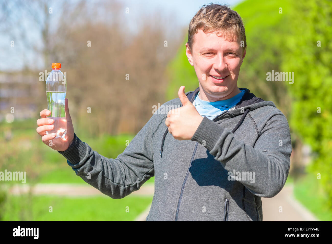 satisfied man with a bottle of drinking water Stock Photo - Alamy