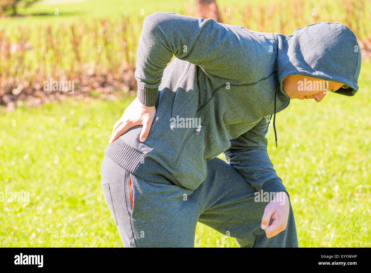 bent man holding his hand sore back Stock Photo - Alamy