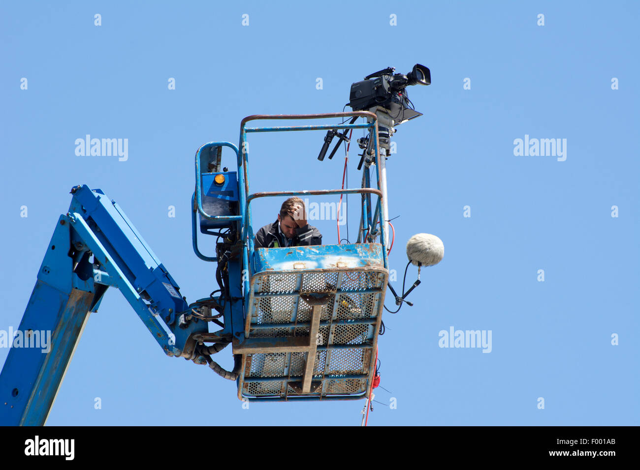 Professional sports video cameraman at Silverstone F1 GP 2015 on crane ...