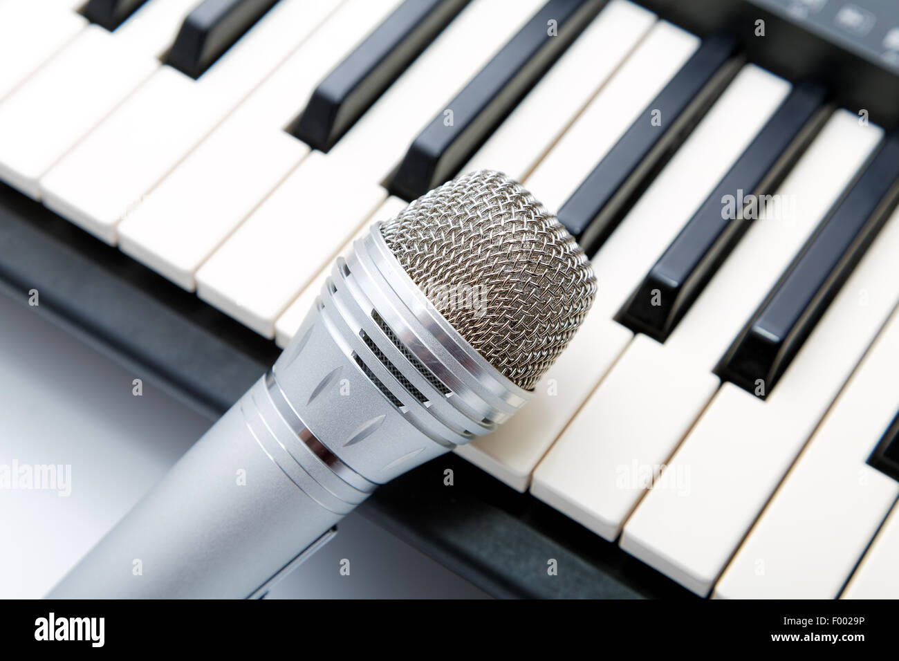 The microphone lies on the synthesizer keyboard Stock Photo - Alamy