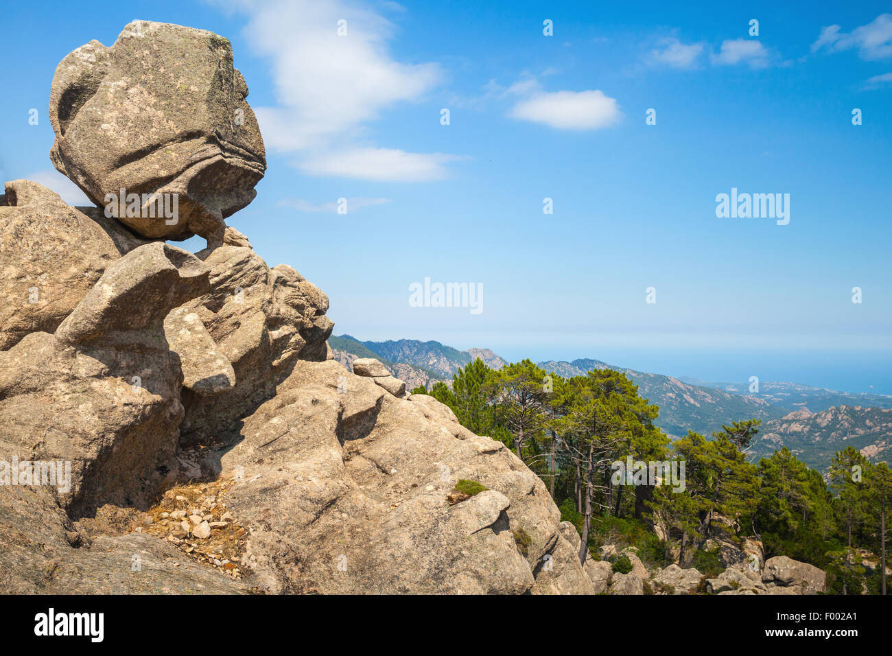 Big round stone lays on top of a coastal rock, Corsica island, Ospedale ...