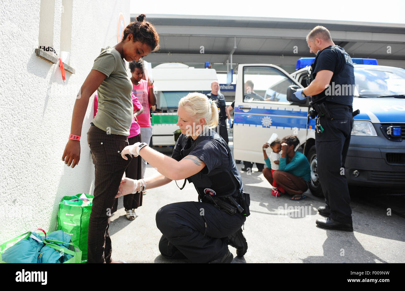 Rosenheim, Germany. 04th Aug, 2015. Ruth from Eritrea is frisked by ...