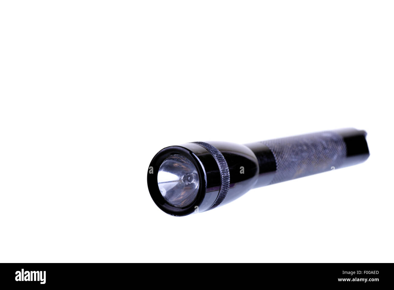 Small black flashlight isolated on a white background with copy space ...