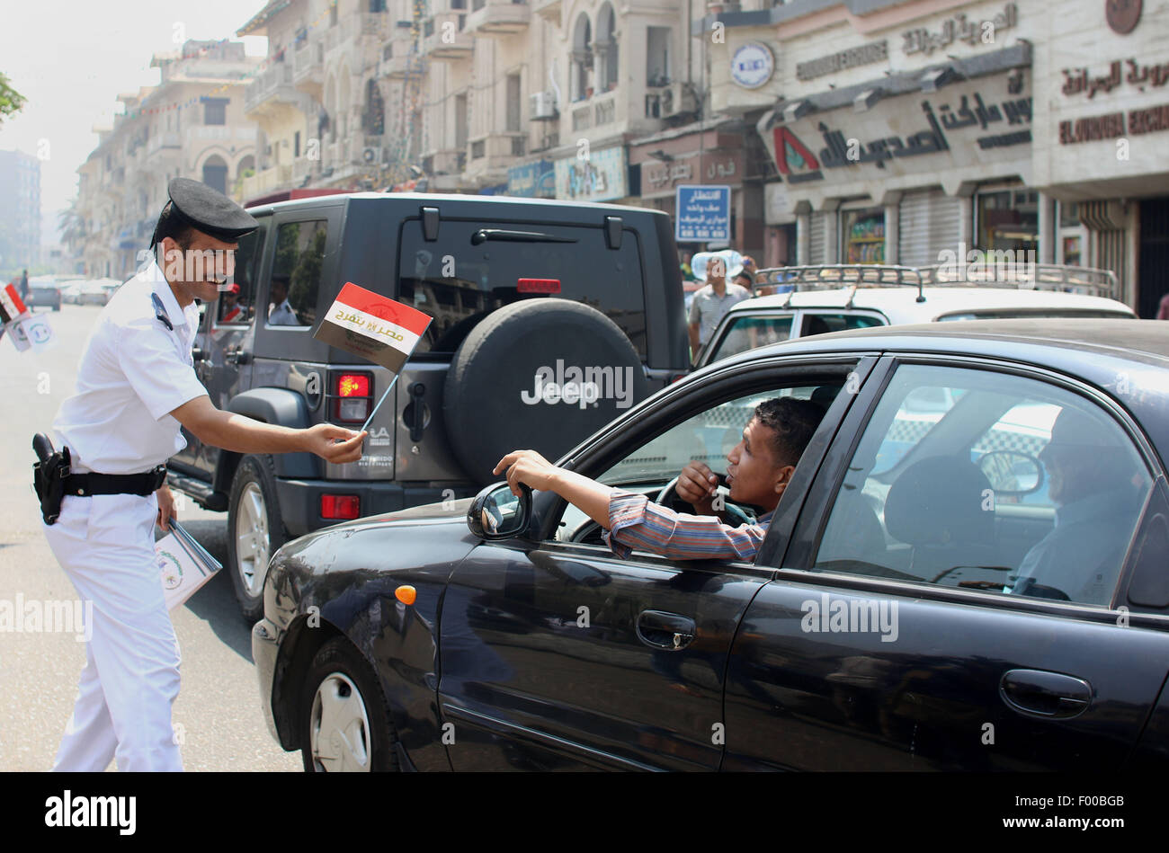 Cairo, Egypt. 5th Aug, 2015. An Egyptian police officer distributes ...