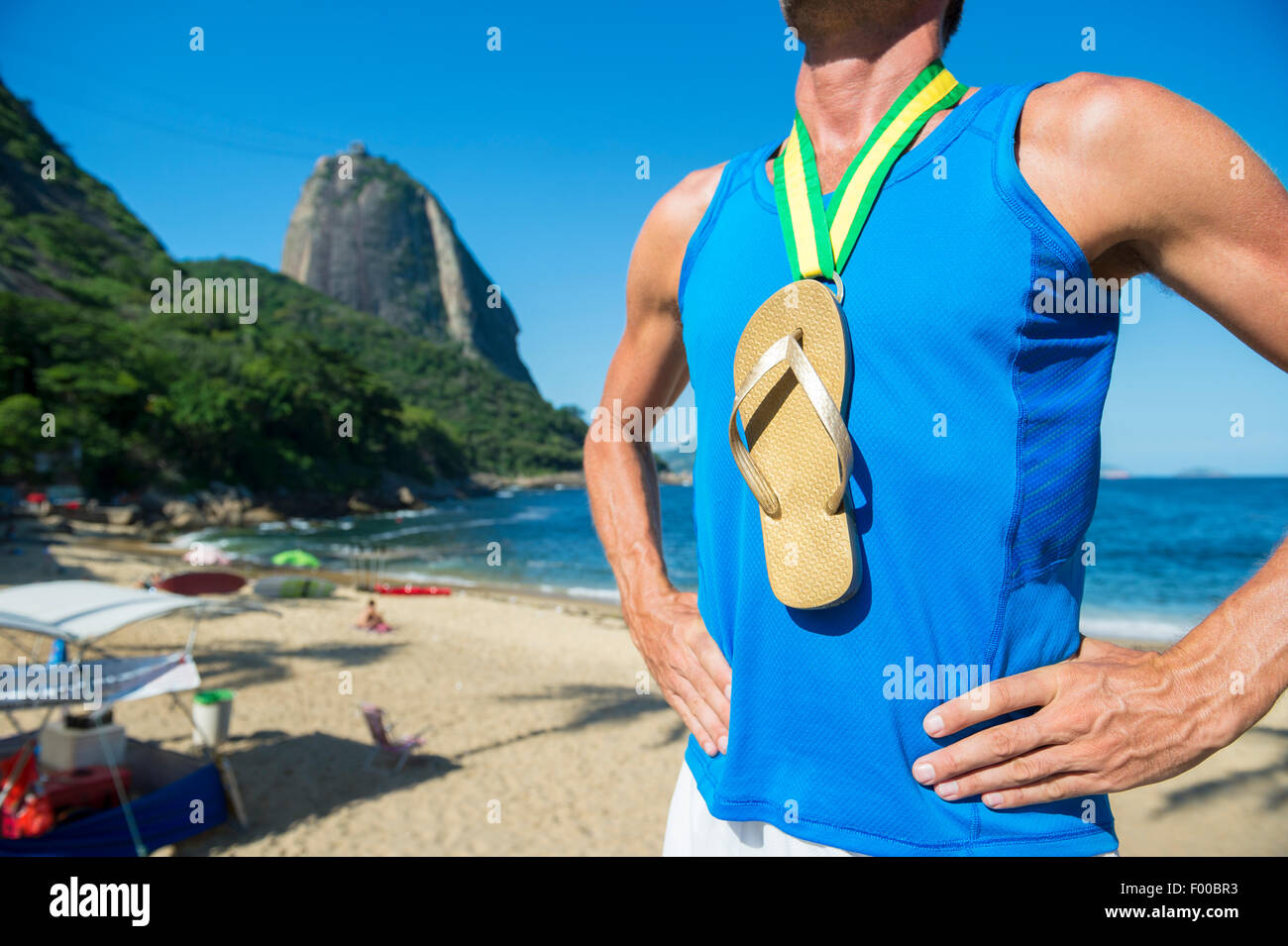 Champion athlete wearing gold medal flip flop celebrating at Red Beach ...
