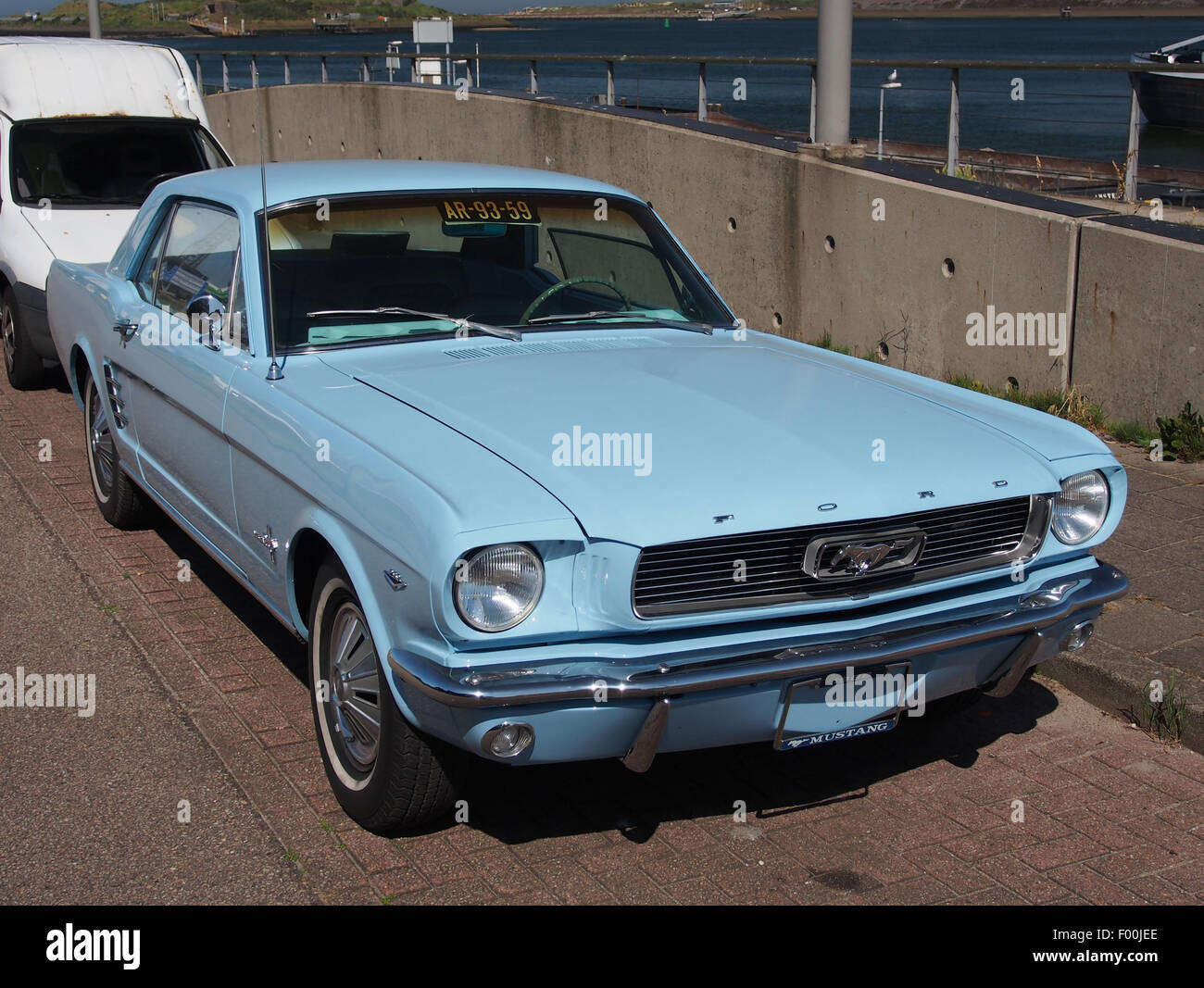 A light blue 1966 Ford Mustang, a classic American muscle car known for ...