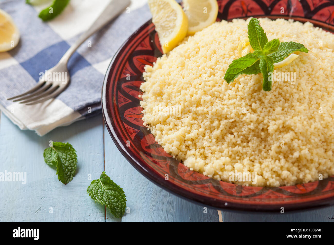 Decorated bowl with boiled couscous with mint and lemon Stock Photo - Alamy