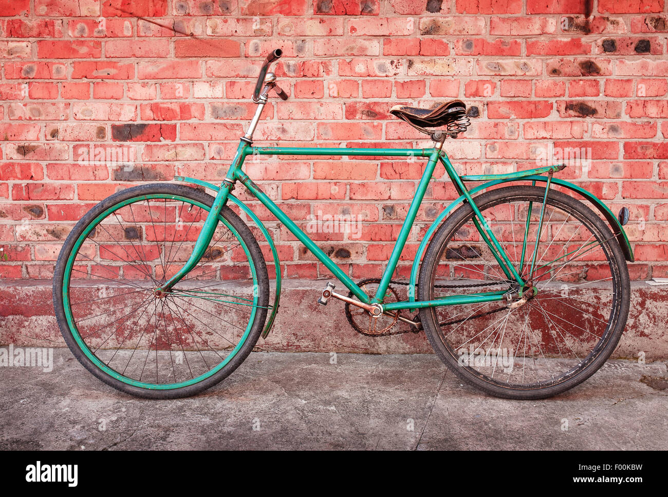 Old retro bicycle against brick wall Stock Photo - Alamy