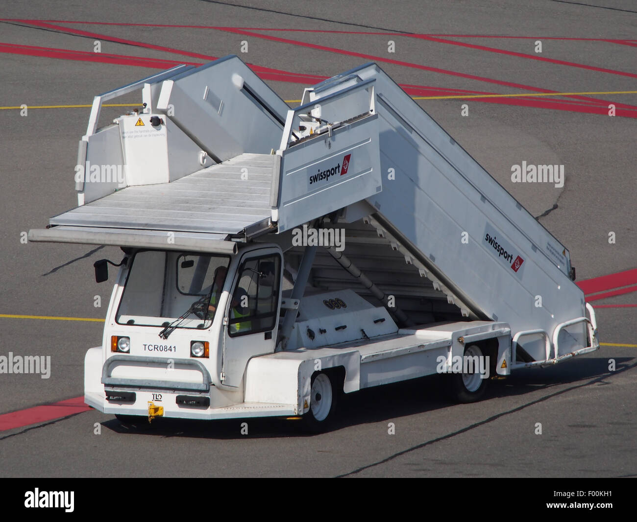 Mobile stairs are positioned at Amsterdam Airport (Schiphol), providing ...