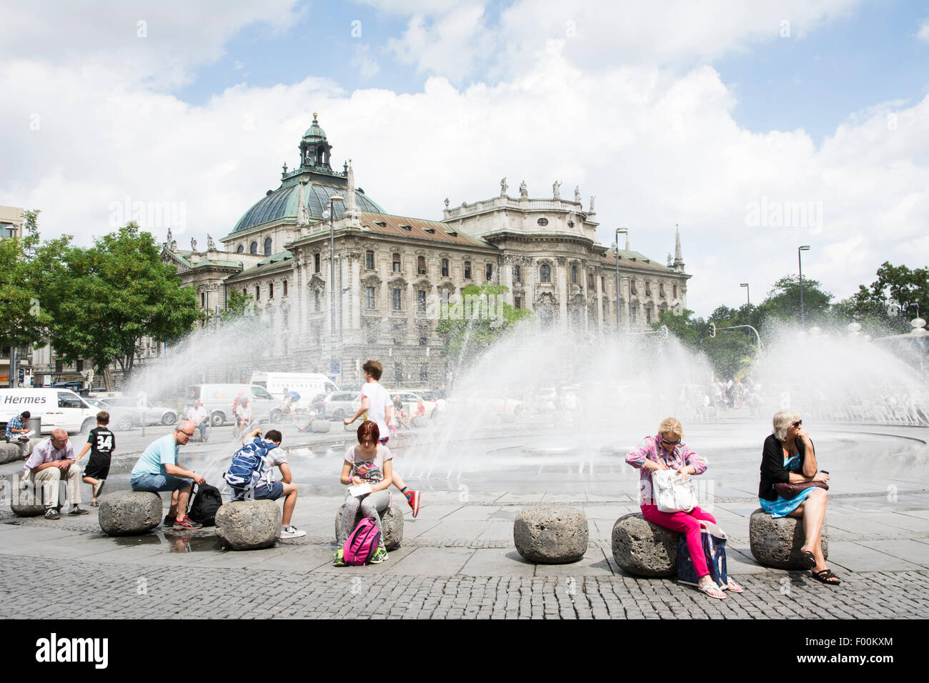 MUNICH, GERMANY - JULY 20: Tourists at Stachus fountain in Munich ...