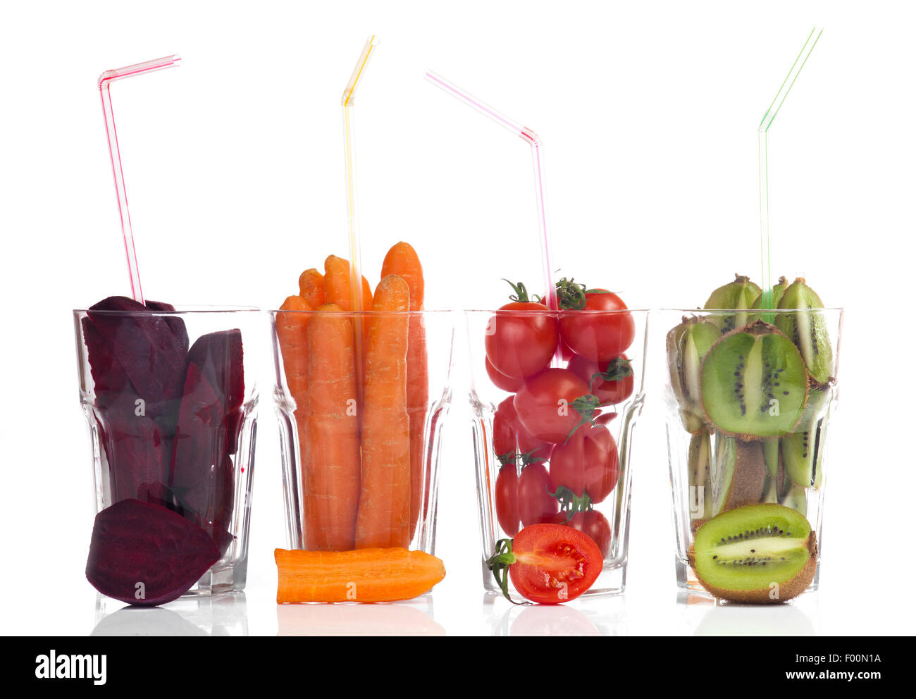 Conceptual image - fresh fruits and vegetables in glass cups on a white ...
